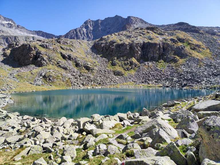 Alpine lake trail to Corno Baitone Summit from Rifugio Tonolini ...